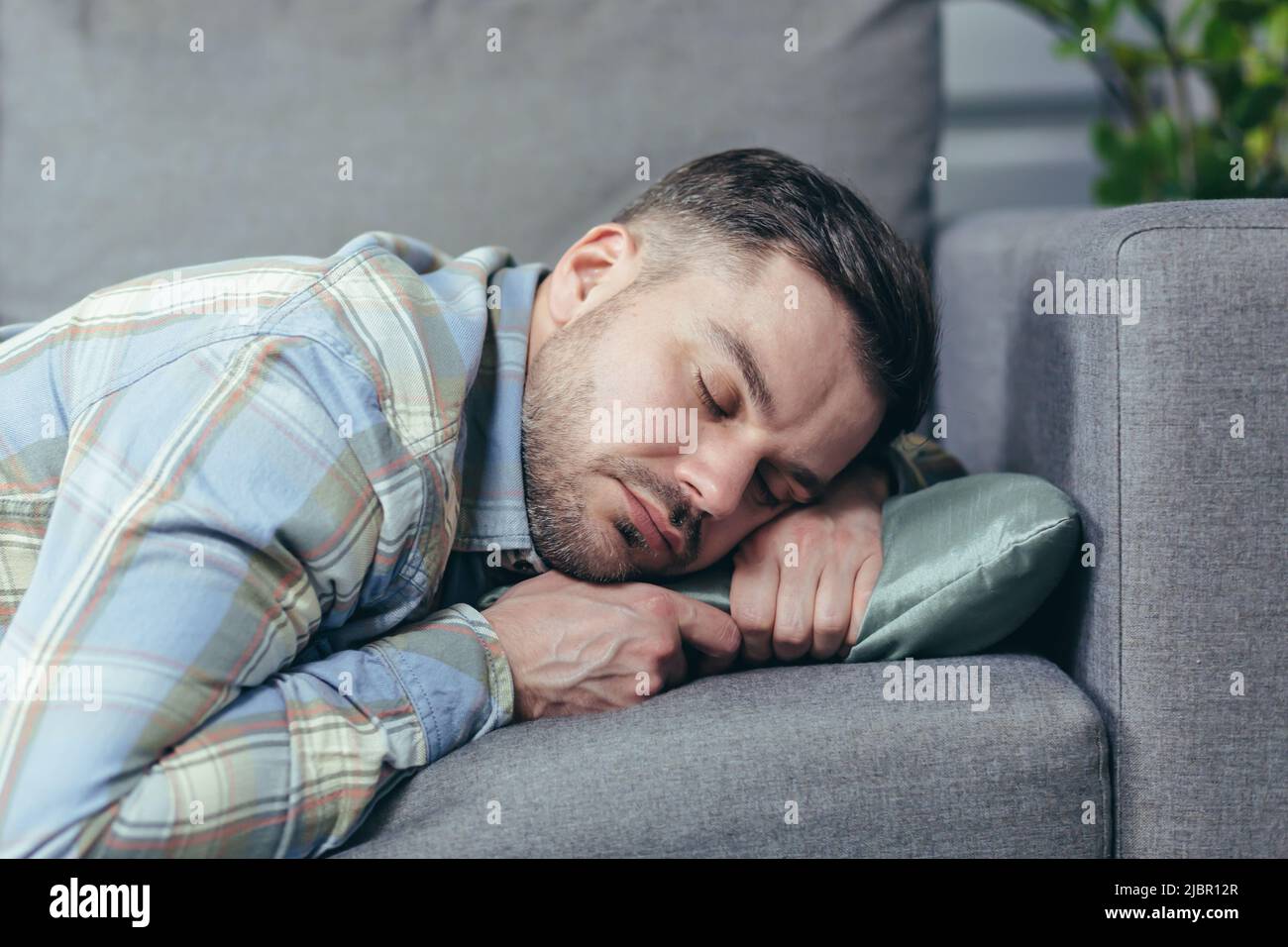 Close up photo of man sleeping on sofa at home Stock Photo - Alamy