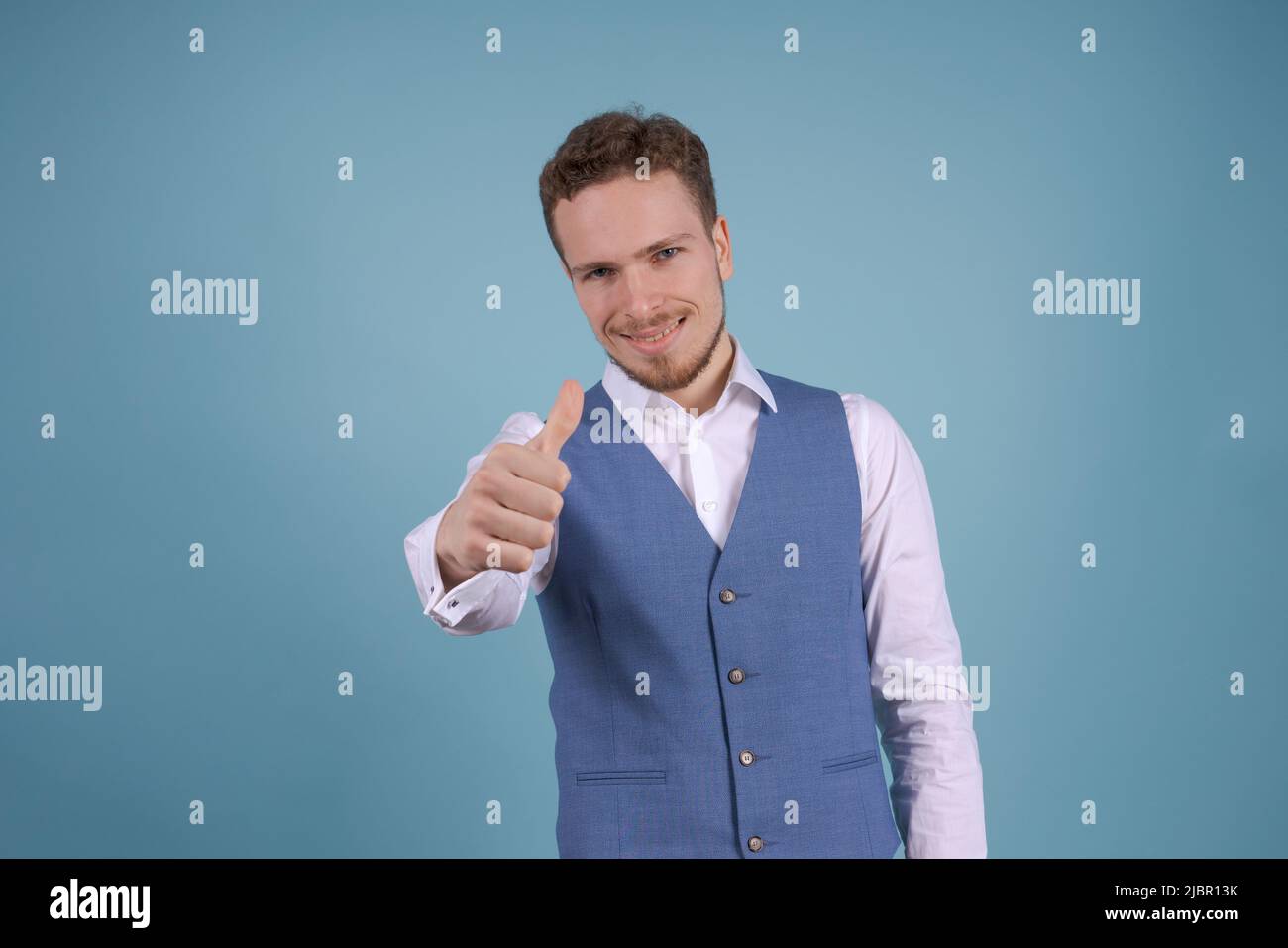 Portrait handsome young man makes normal gesture, shows consent, loves ...