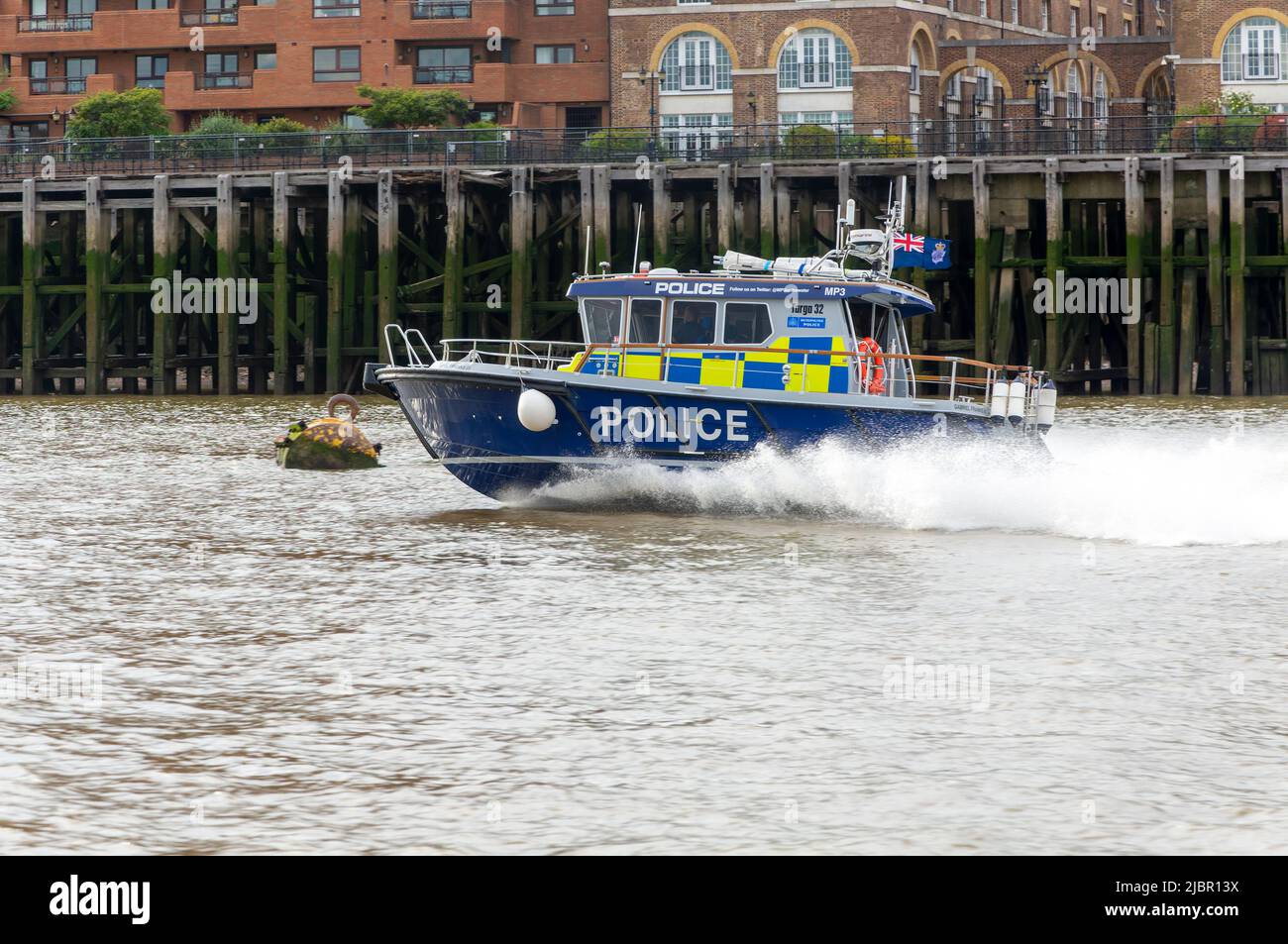 Metropolitan police speedboat motor launch travelling at high speed ...