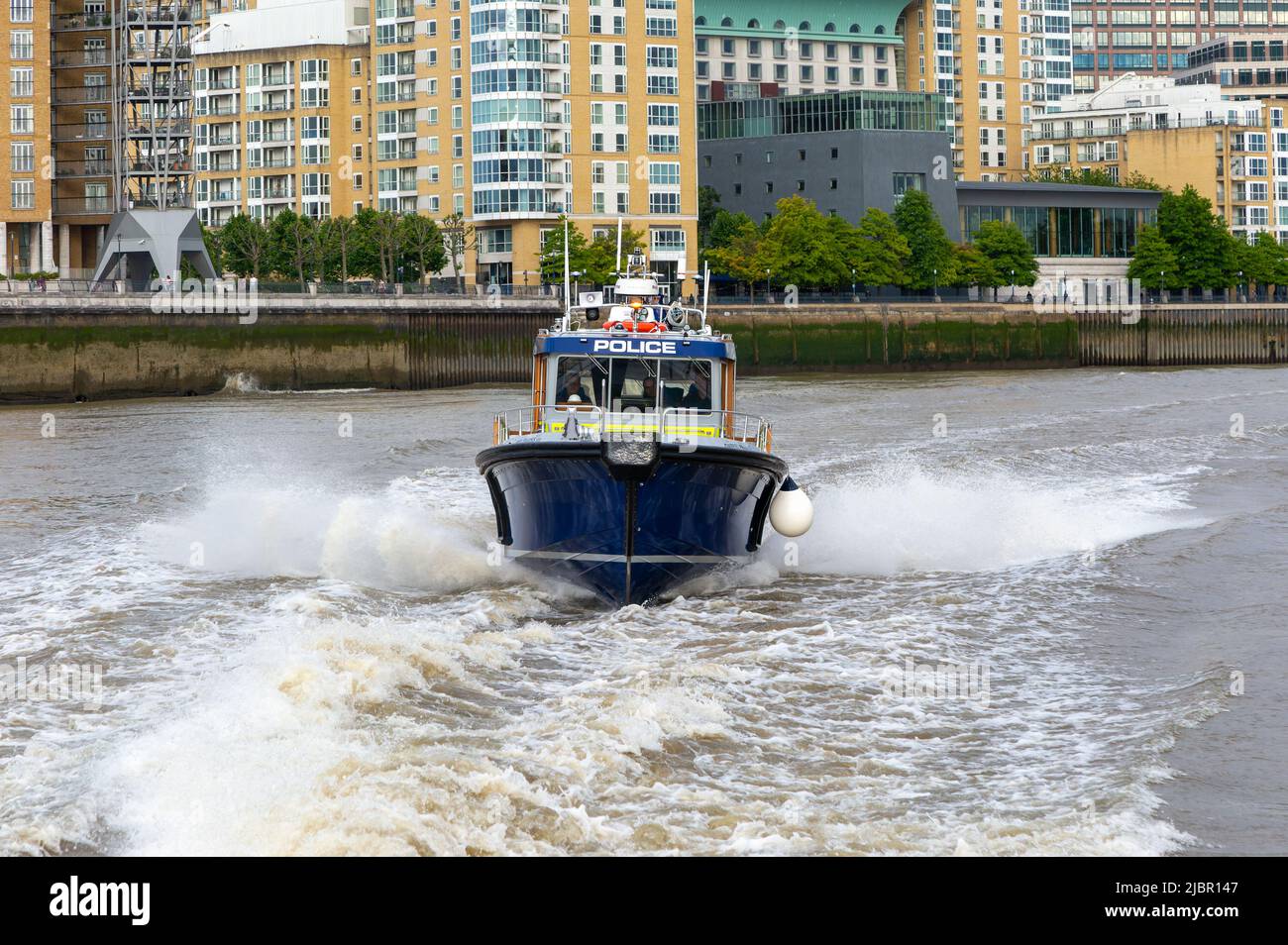 Metropolitan police speedboat motor launch travelling at high speed ...