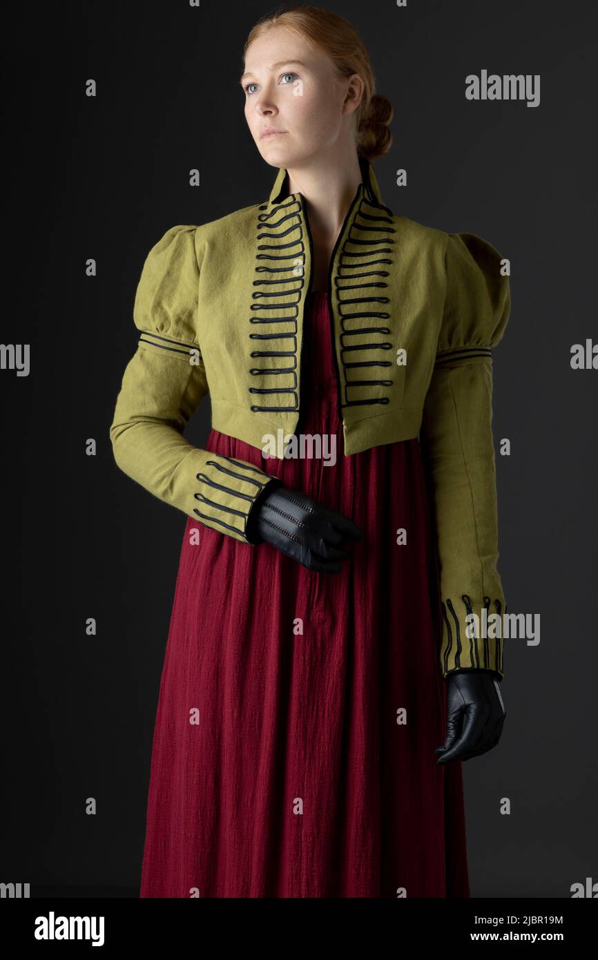 Regency woman wearing a green linen spencer and red dress against a ...