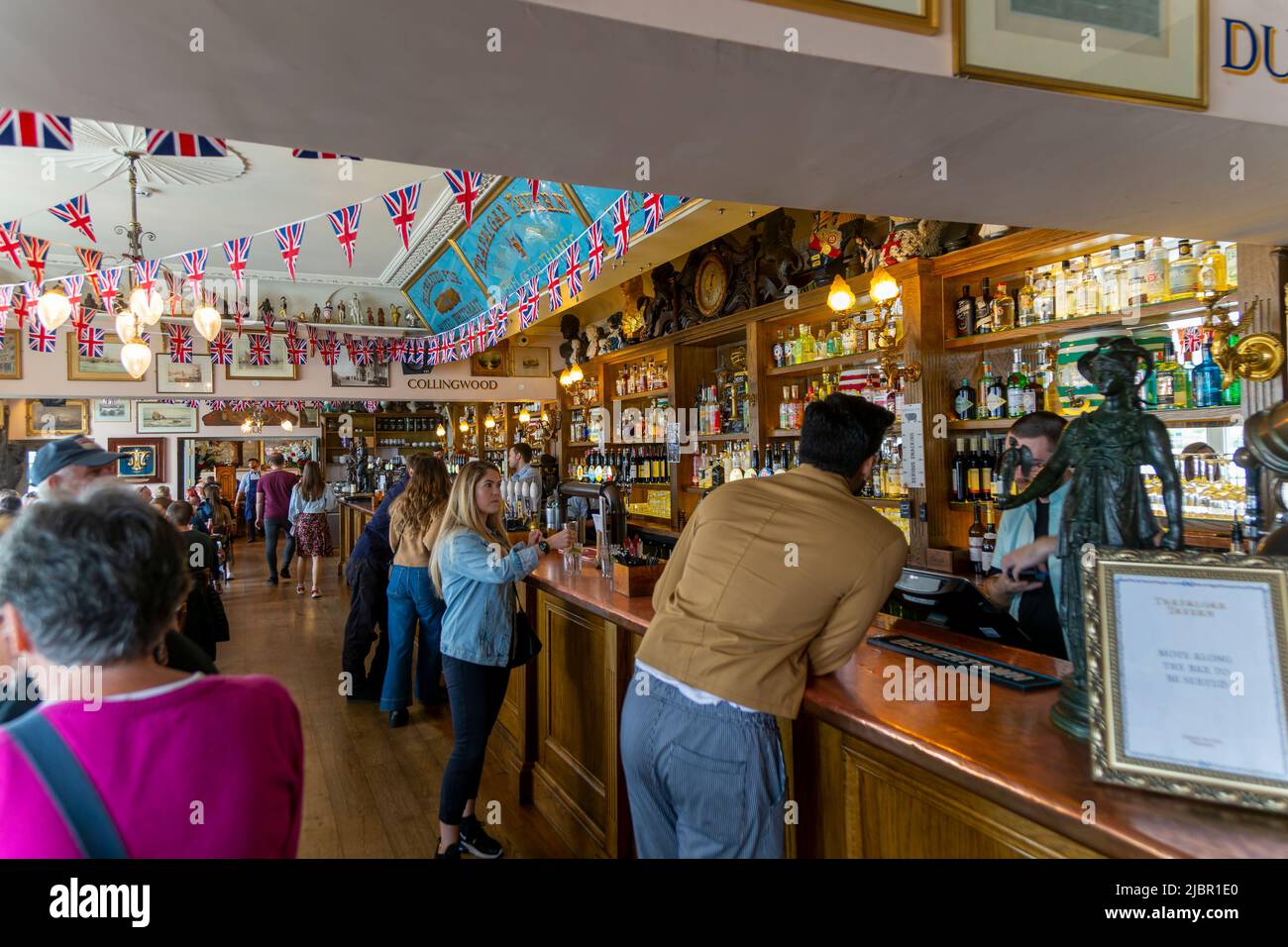 Customers leaning aginst the bar inside the Trafalgar pub, Greenwich ...