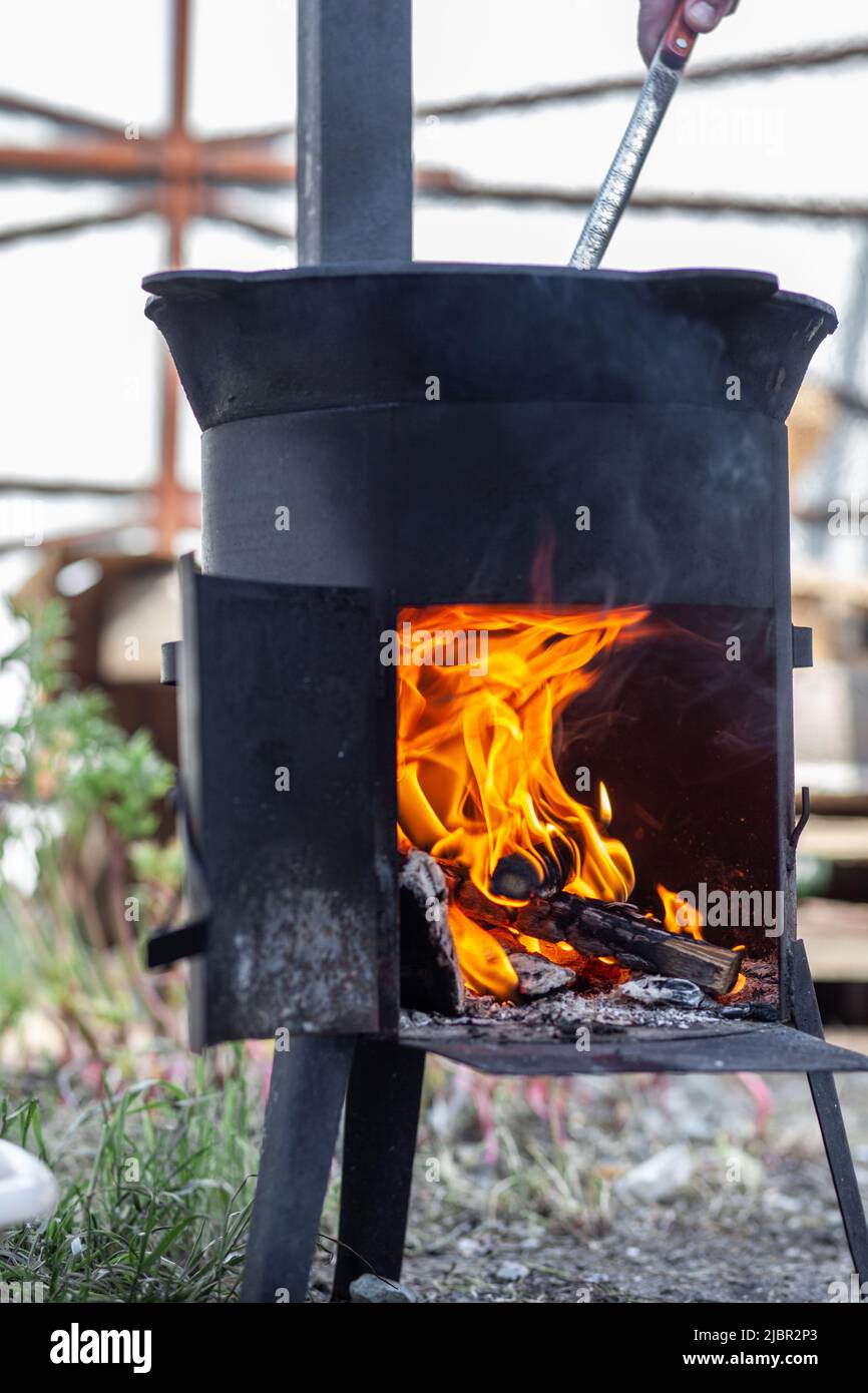 Cooking food or pilaf in a cauldron on fire. Cooking in cauldron on ...