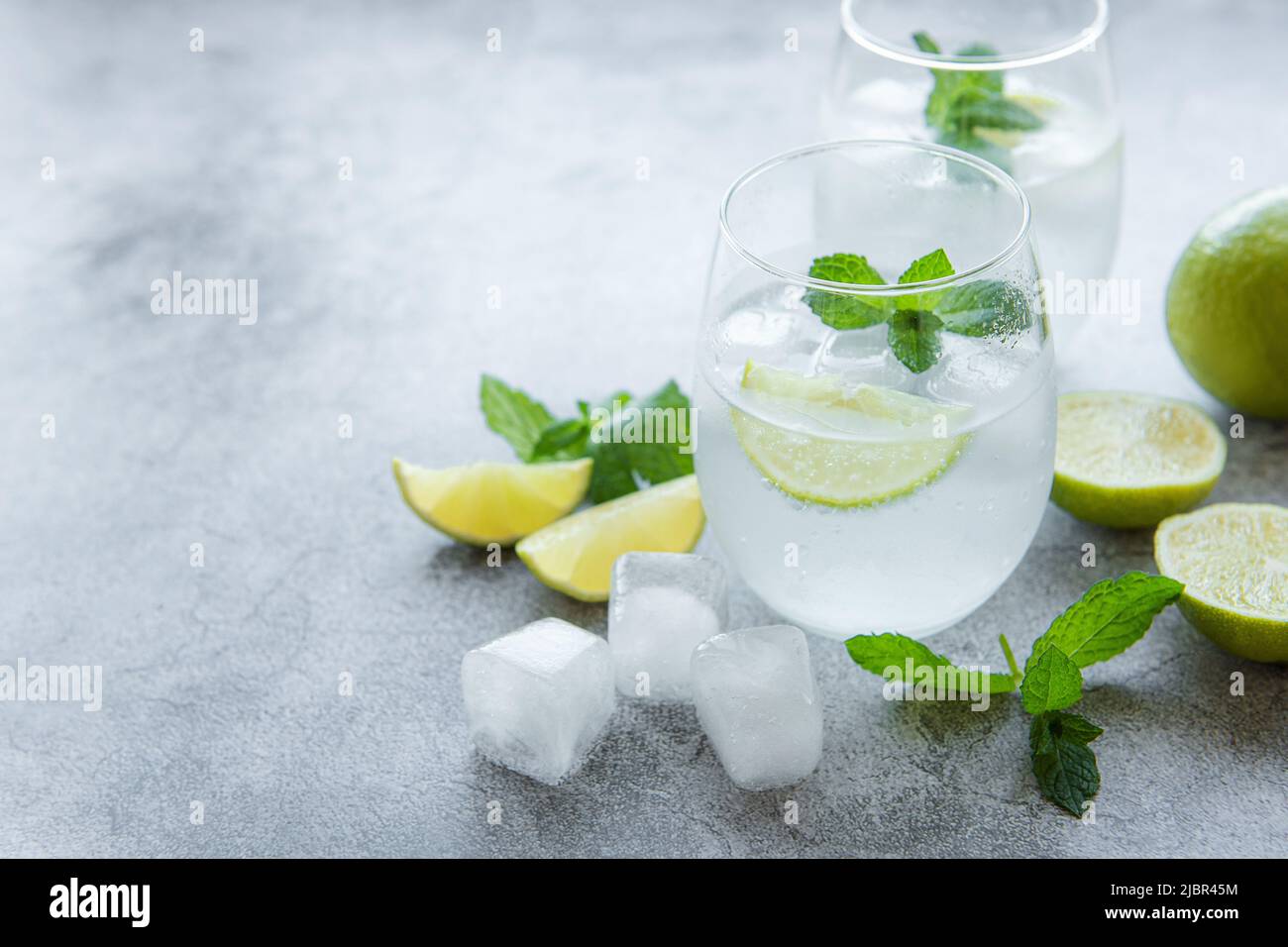 Iced cold lemonade with fresh lime and juice. Summer drink in glass ...