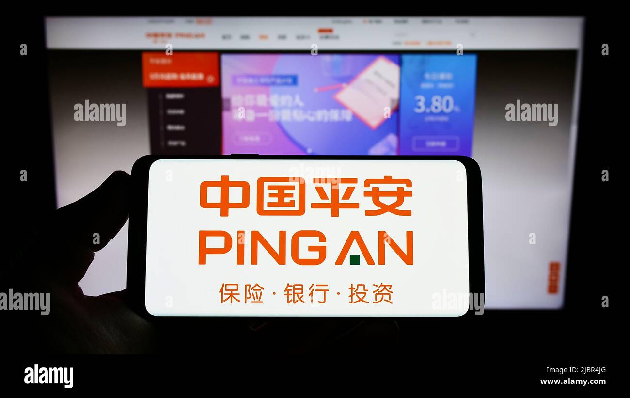 Person holding smartphone with logo of Ping An Insurance (Group ...