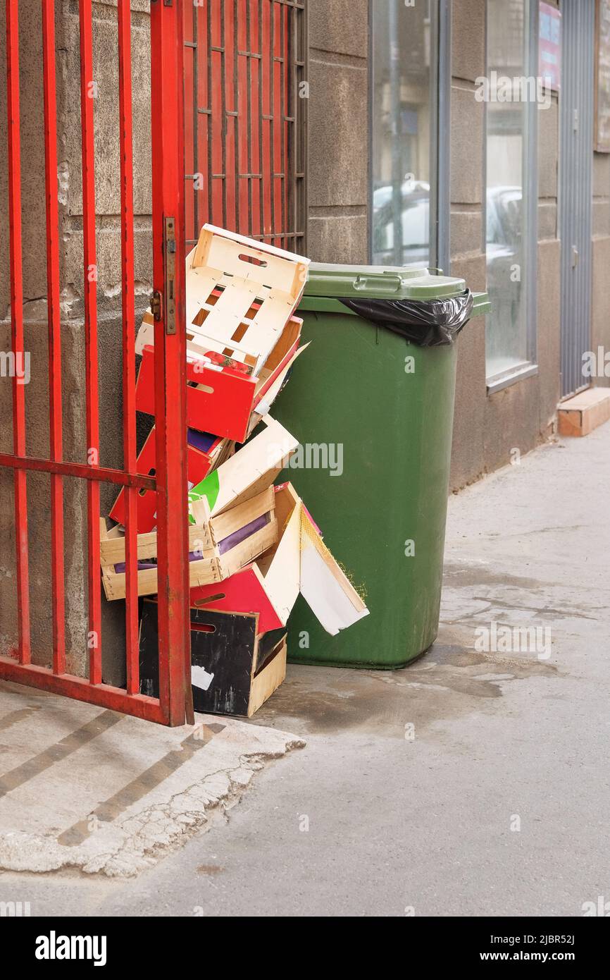 Empty wood boxes are folded for further sorting and processing ...