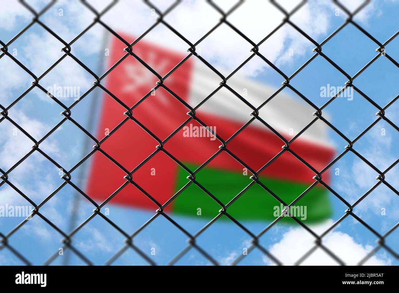 A steel mesh against the background of a blue sky and a flagpole with ...