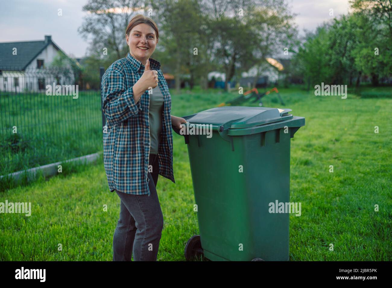 European 20s girl take out the trash can sorting garbage near a home ... European 20s girl take out the trash can sorting garbage near a home ...