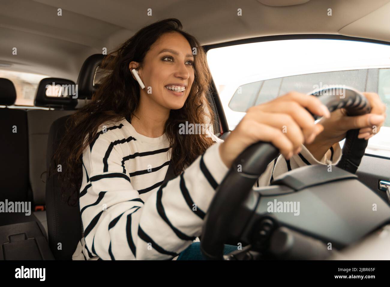 Lady Driving Sitting In Automobile, Listening To Music In Earbuds Stock ...