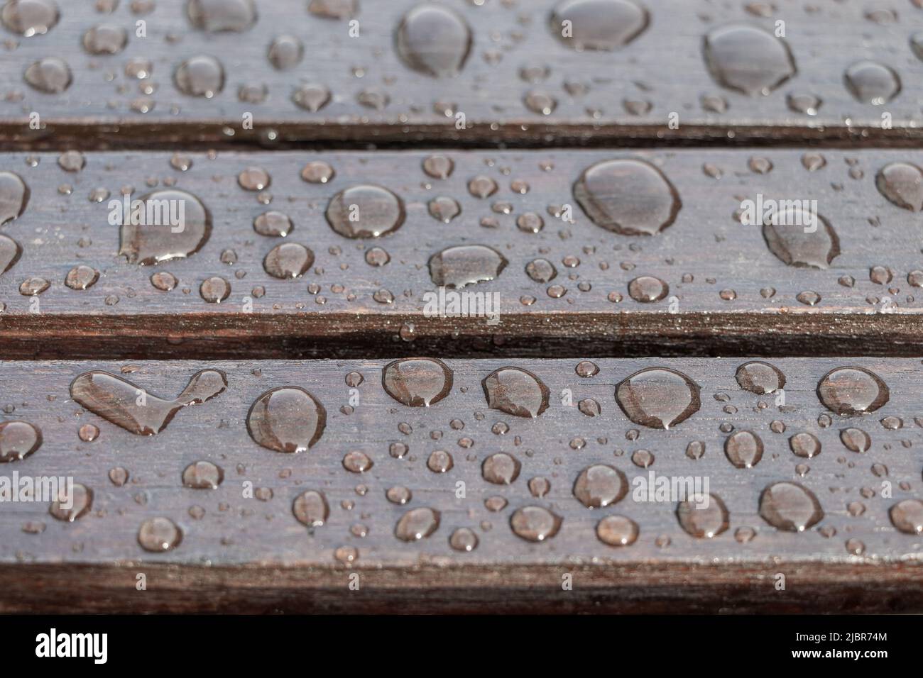 Wooden planks covered by water drops, background for rainy weather. Wet ...