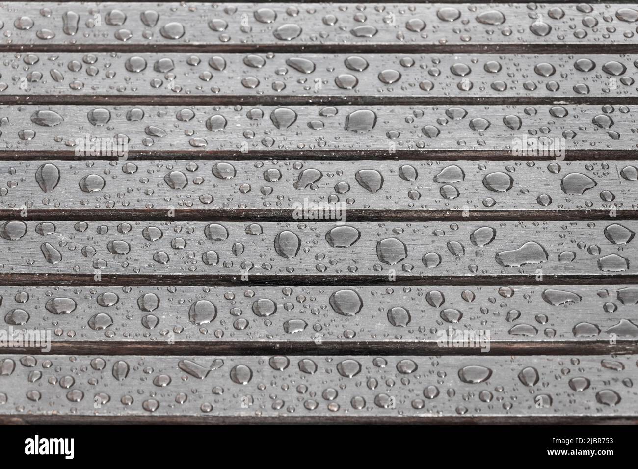 Wooden planks covered by water drops, background for rainy weather. Wet ...
