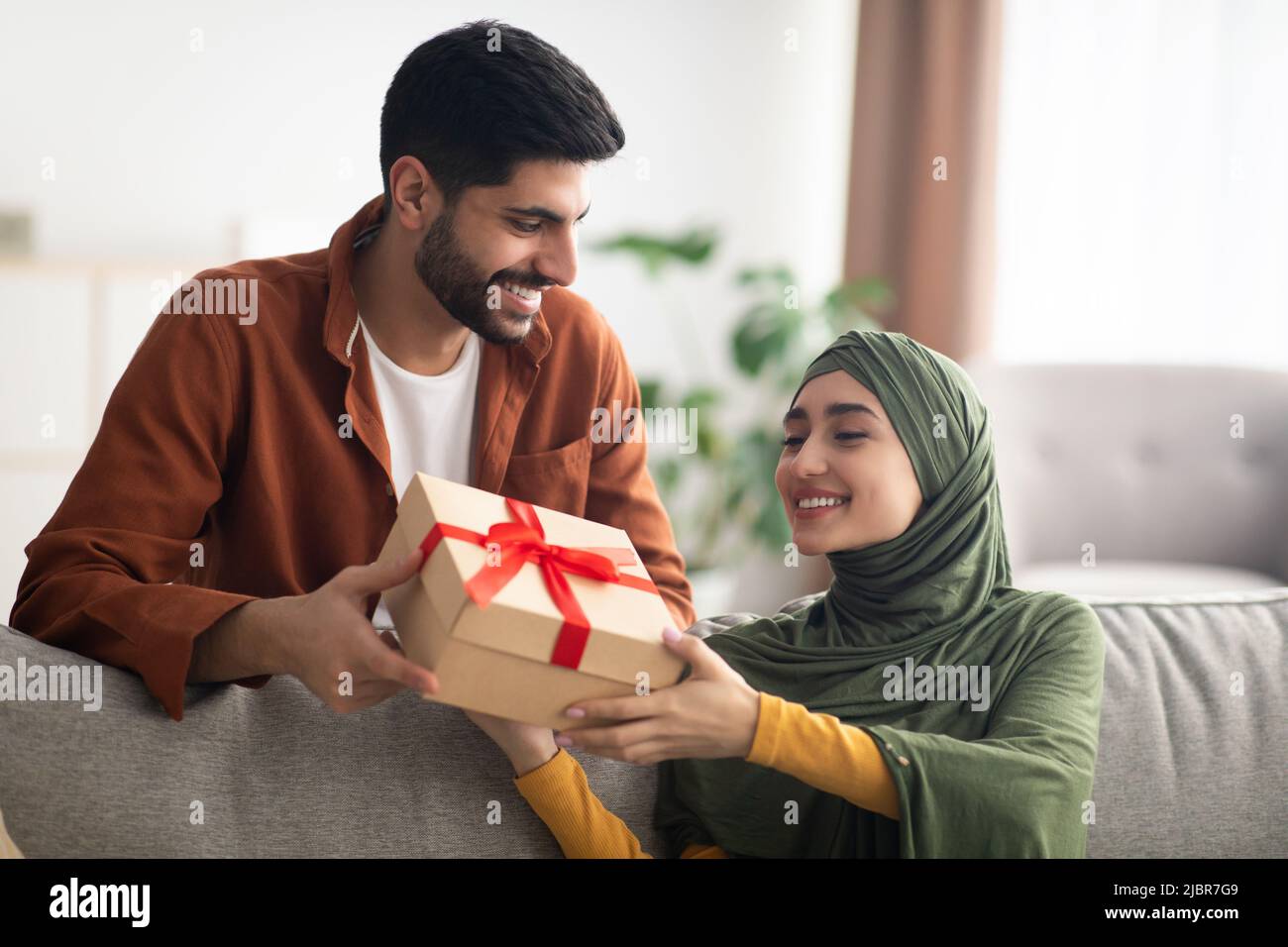 Middle Eastern Husband Giving Present Box Congratulating Wife At Home ...