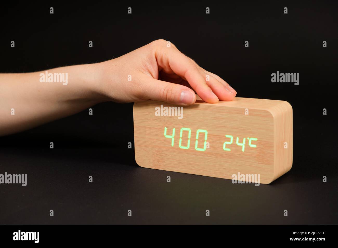 A digital clock showing a time of four o'clock in the morning and a ...