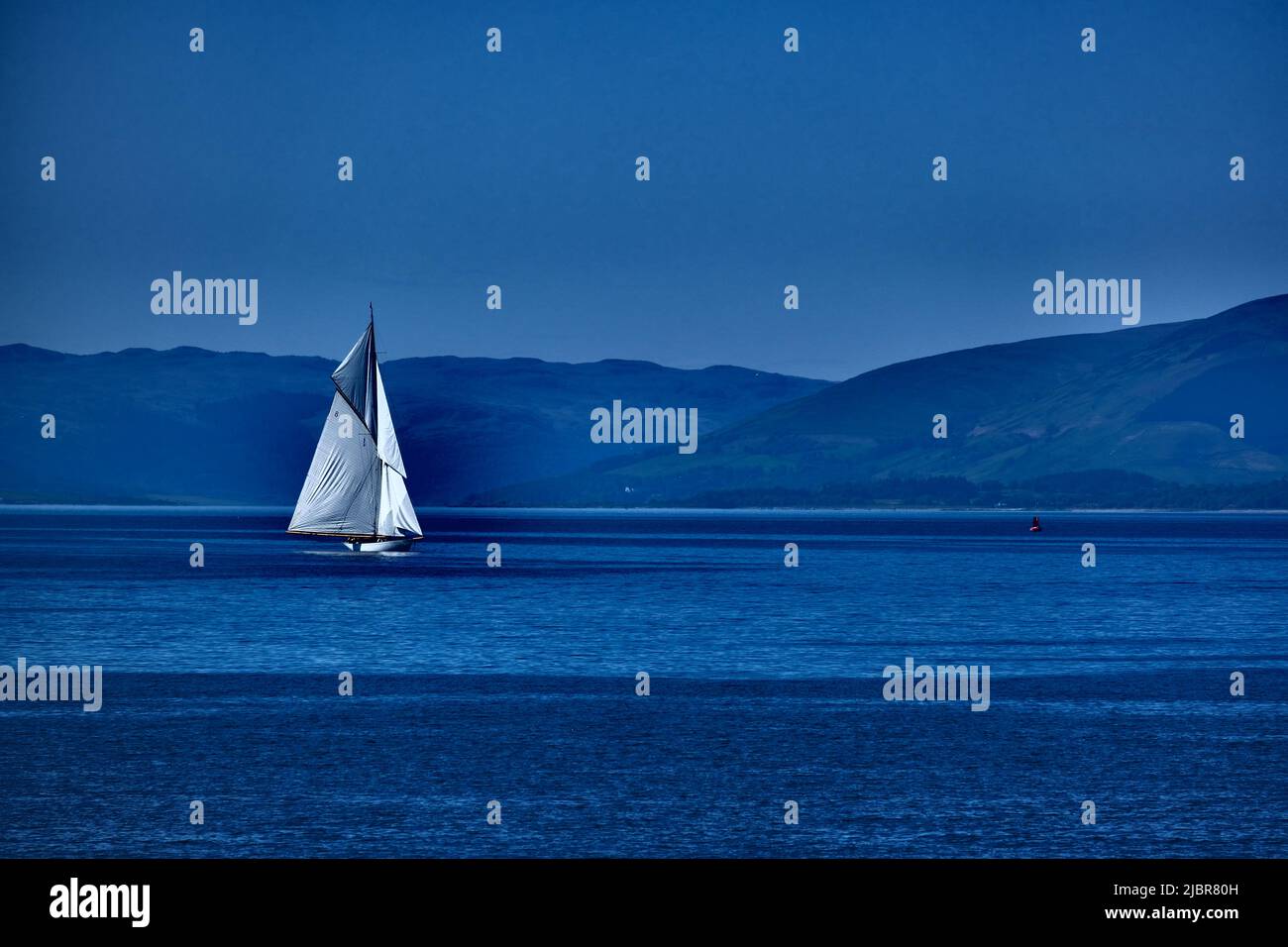 Sailing boat on the sea in front of mountains, Largs Scotland Stock ...
