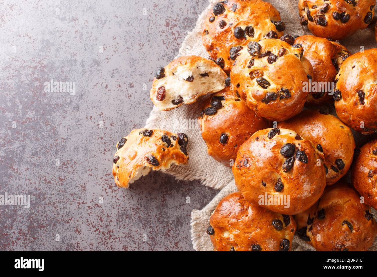 Freshly baked buns with raisins traditional european pastry close-up on ...