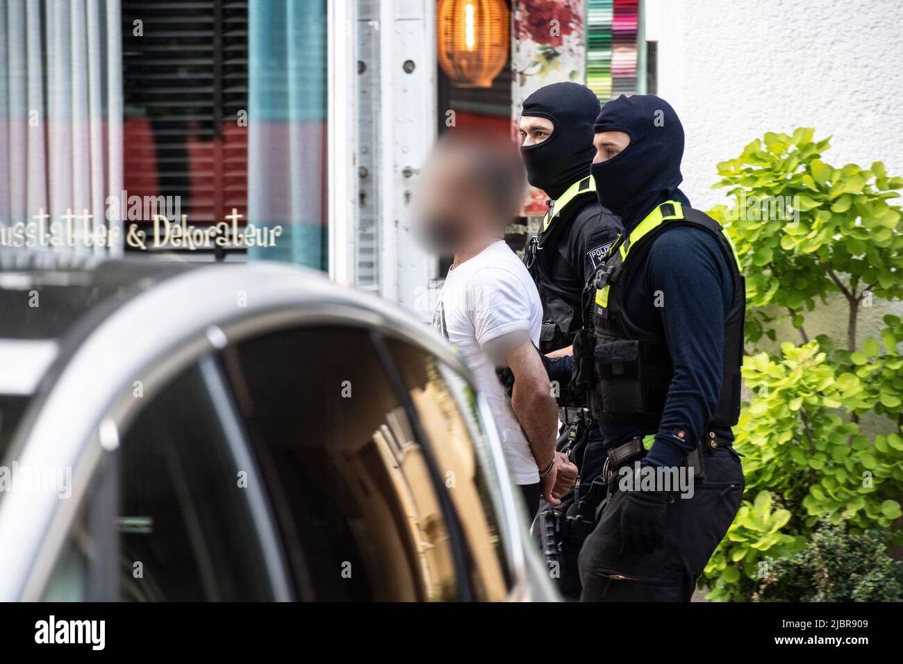 Berlin, Germany. 08th June, 2022. Masked police officers lead away a ...