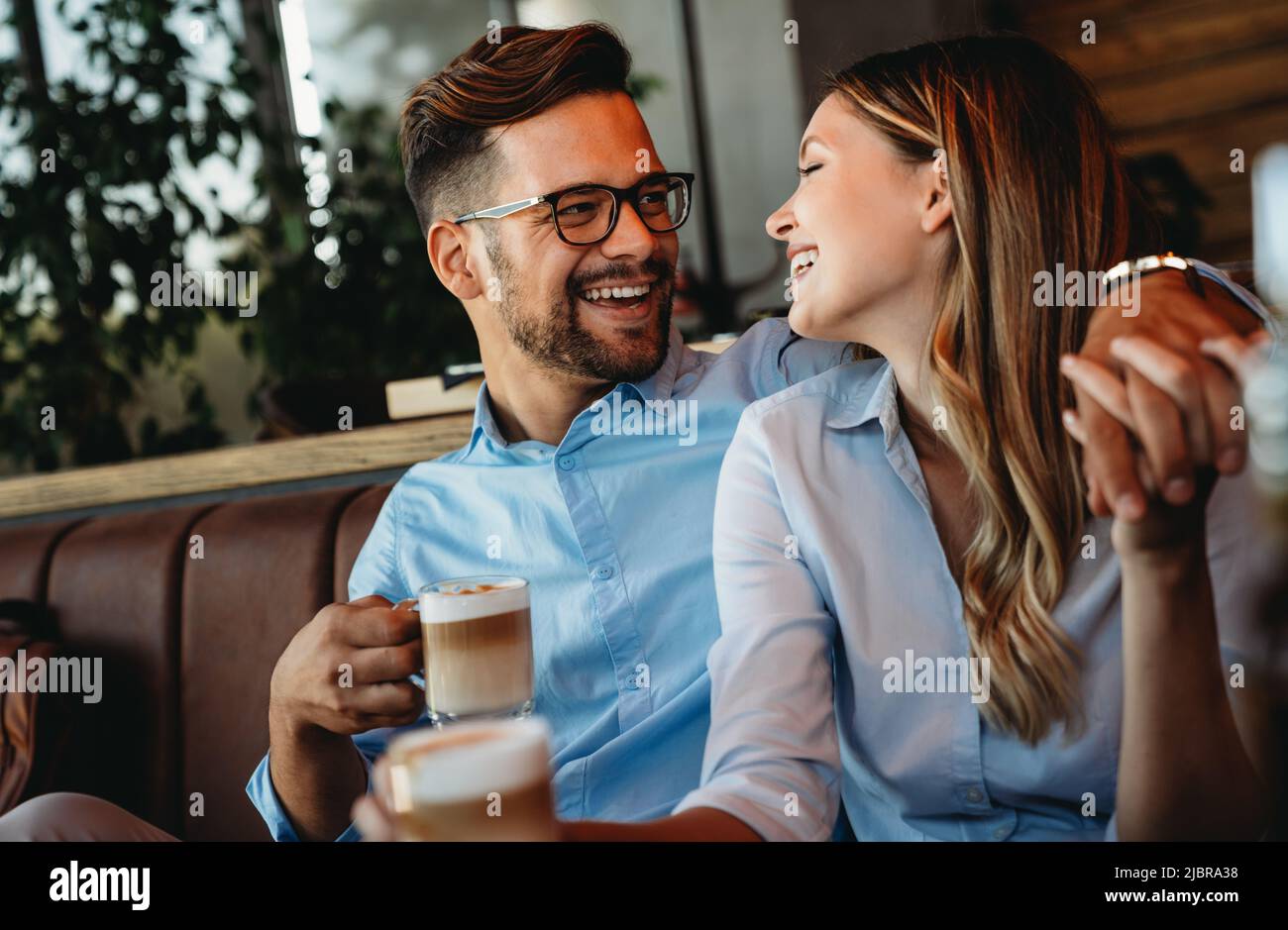 Romantic loving couple drinking coffee, having a date in the cafe Stock ...