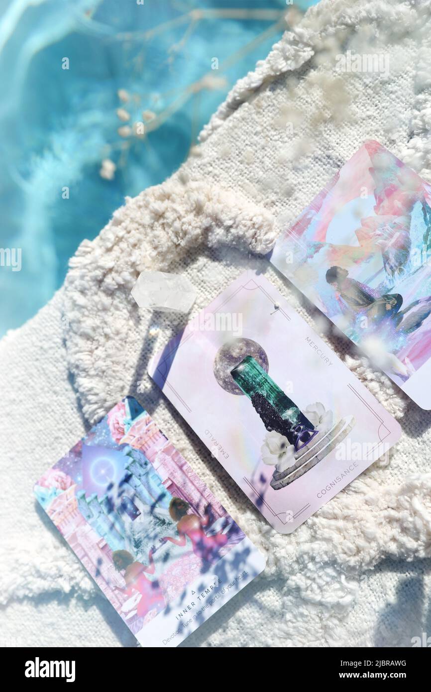 Oracle cards and clear quartz crystal on poolside bohemian picnic rug ...