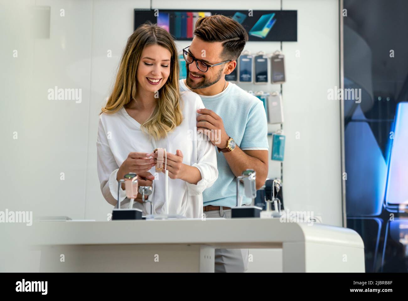 Happy young people buying new digital gadgets in store. Tecgnology ...