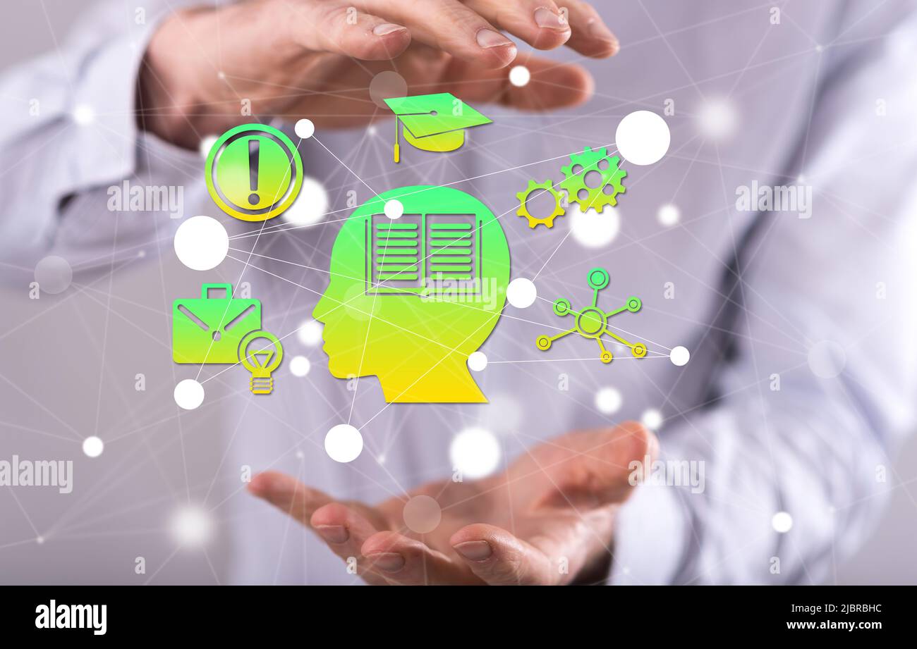 Knowledge concept between hands of a man in background Stock Photo - Alamy