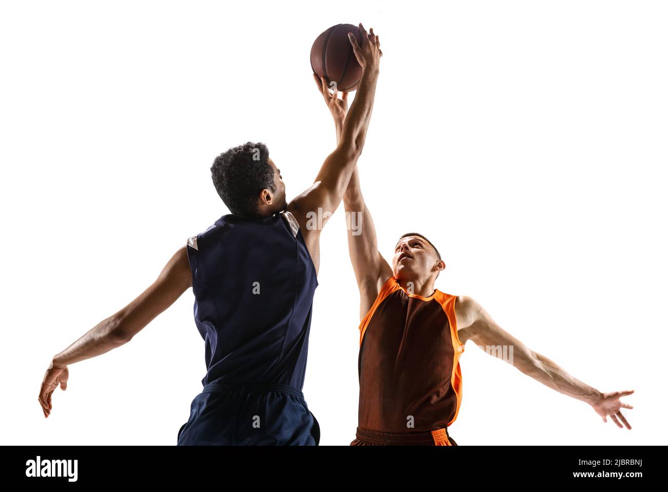 Portrait of two young men, professional basketball players in motion ...
