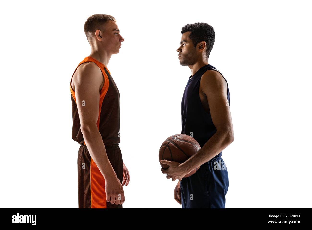 Portrait of two young men, basketball players looking at each other ...