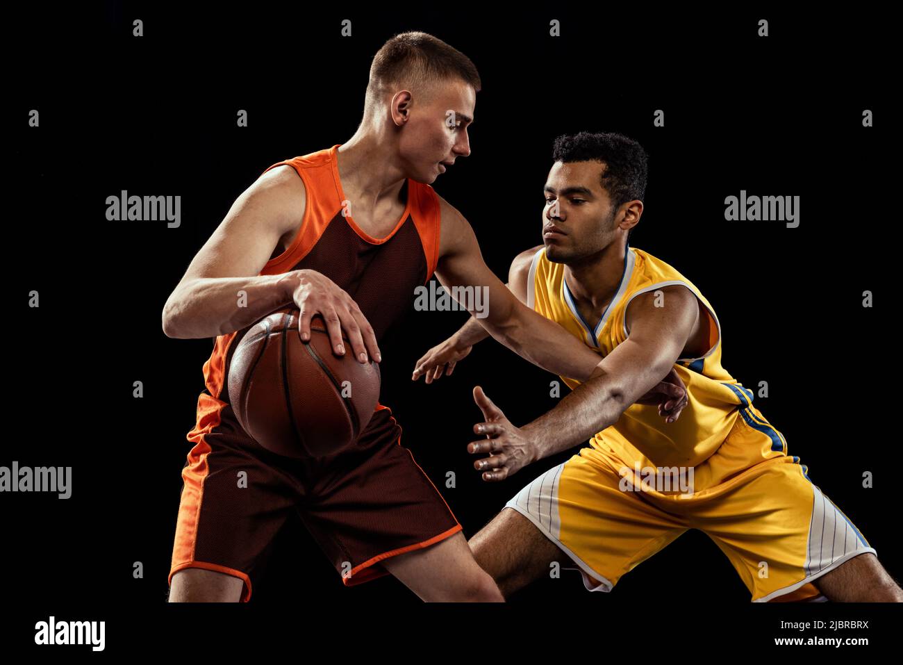 Portrait of two young men, basketball players in uniform training ...