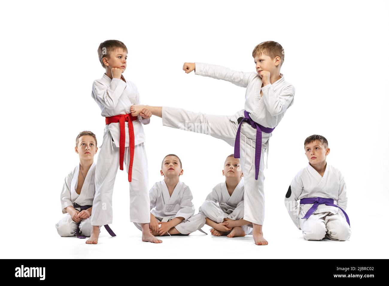 Little beginner karate fighters in white doboks and colorful belts ...