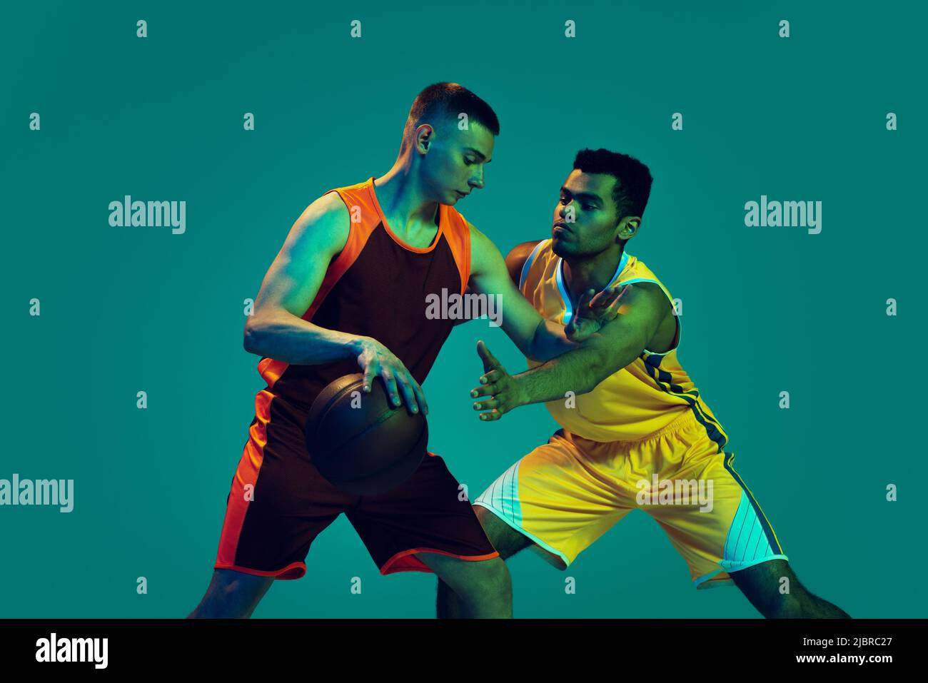 Portrait of two young men, basketball players in uniform training ...