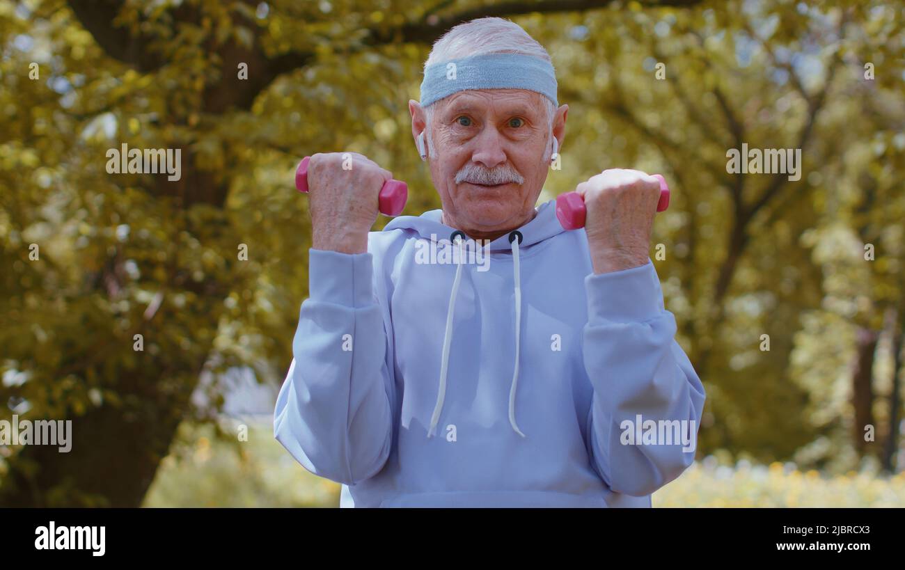 Fitness for seniors. Strong elderly old man exercising making dumbbell ...
