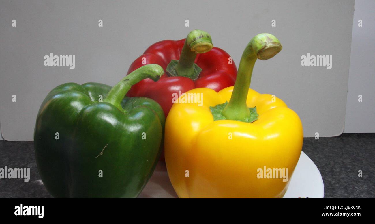 red, yellow and green stalk peppers rotate Stock Photo - Alamy