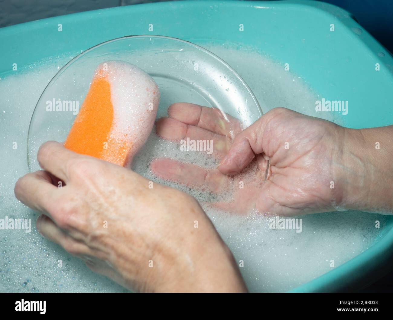Hand washing dishes. Washing the plate with a foam sponge. Lots of foam ...