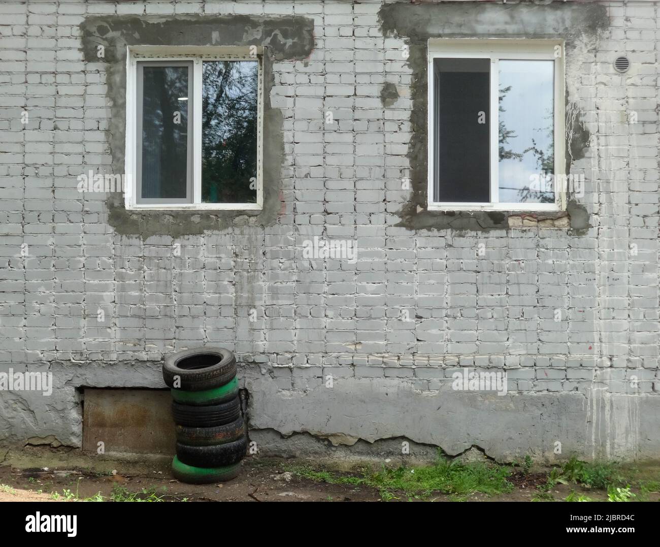 New windows in the slum. Old house. Shack. Stacked car tires Stock ...