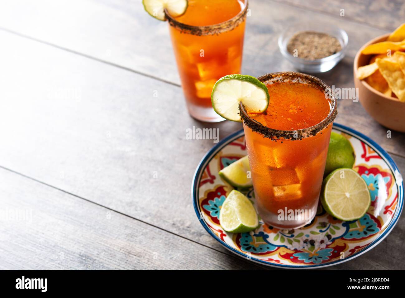 Homemade michelada cocktail with beer, lime juice,hot sauce,salted rim ...