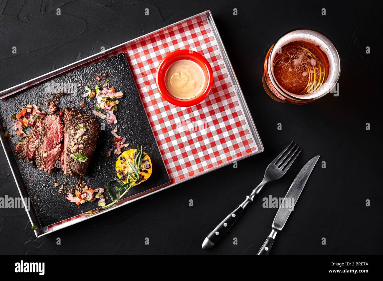 Sliced medium rare grilled Beef steak Ribeye with corn, rosemary, onion ...