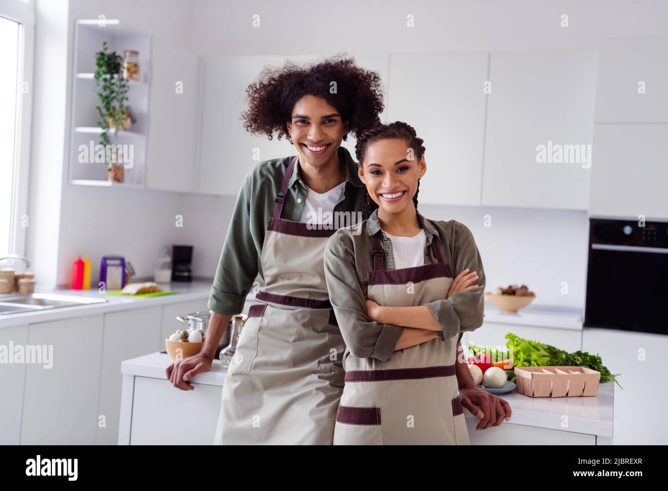 Photo of confident shiny brother sister wear aprons smiling cook ...