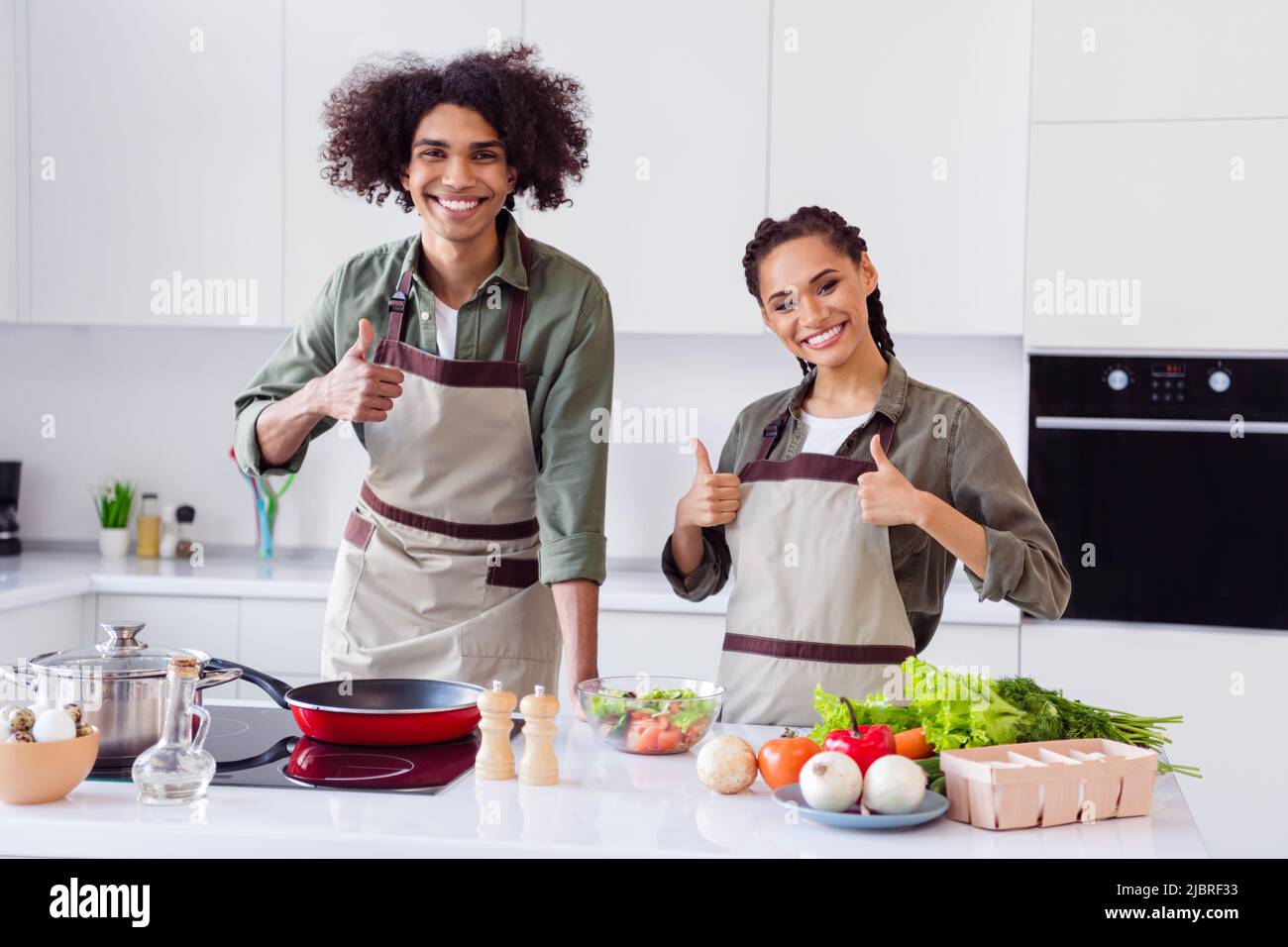 Photo of cheerful confident brother sister wear aprons smiling cook ...