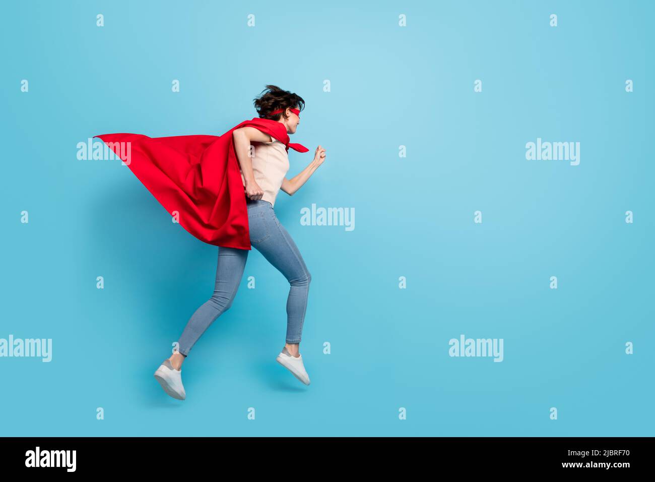 Full length photo of pretty strong woman wear red cape jumping high ...