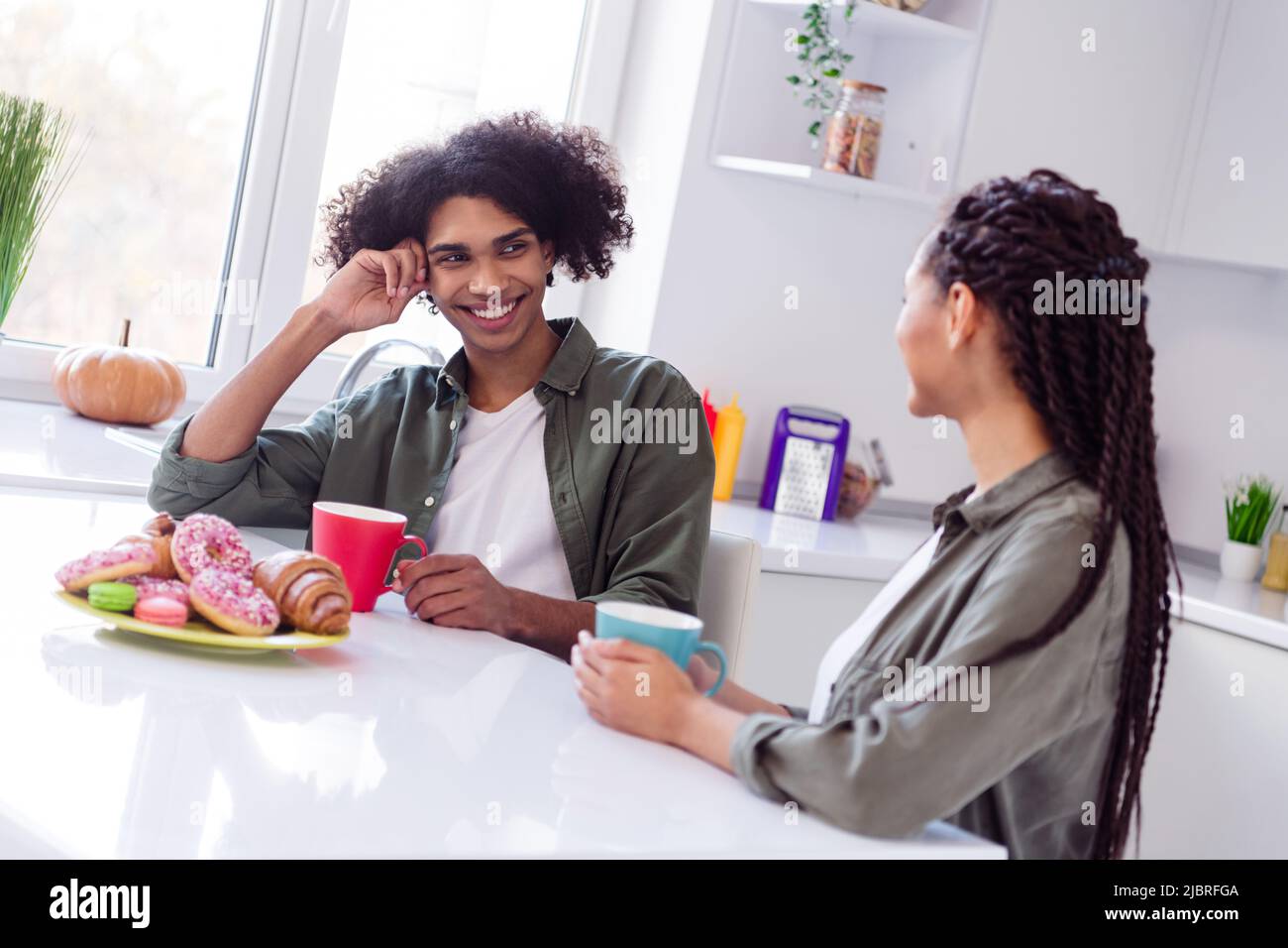 Photo of lovely couple have conversation in kitchen room drinking hot ...
