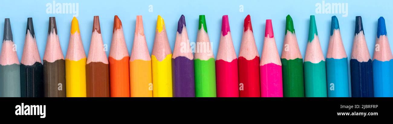 set of colored pencils isolated on blue background Top view Flat lay ...
