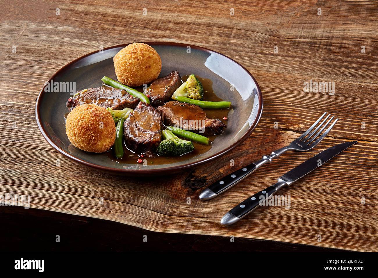 Stewed beef with vegetables on wooden background close up. Hot Meat ...