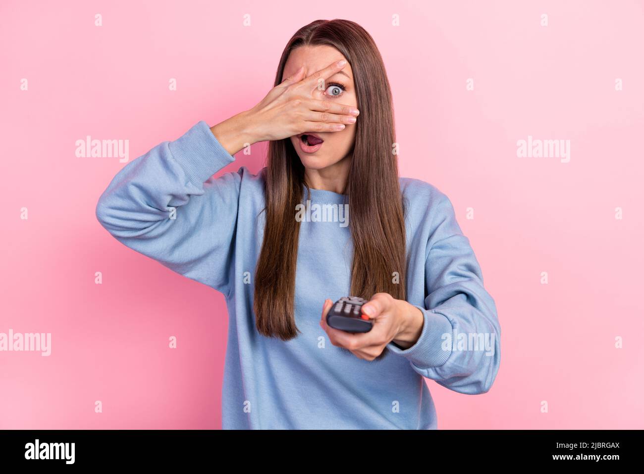 Portrait of attractive scared girl hiding face look horror movie ...