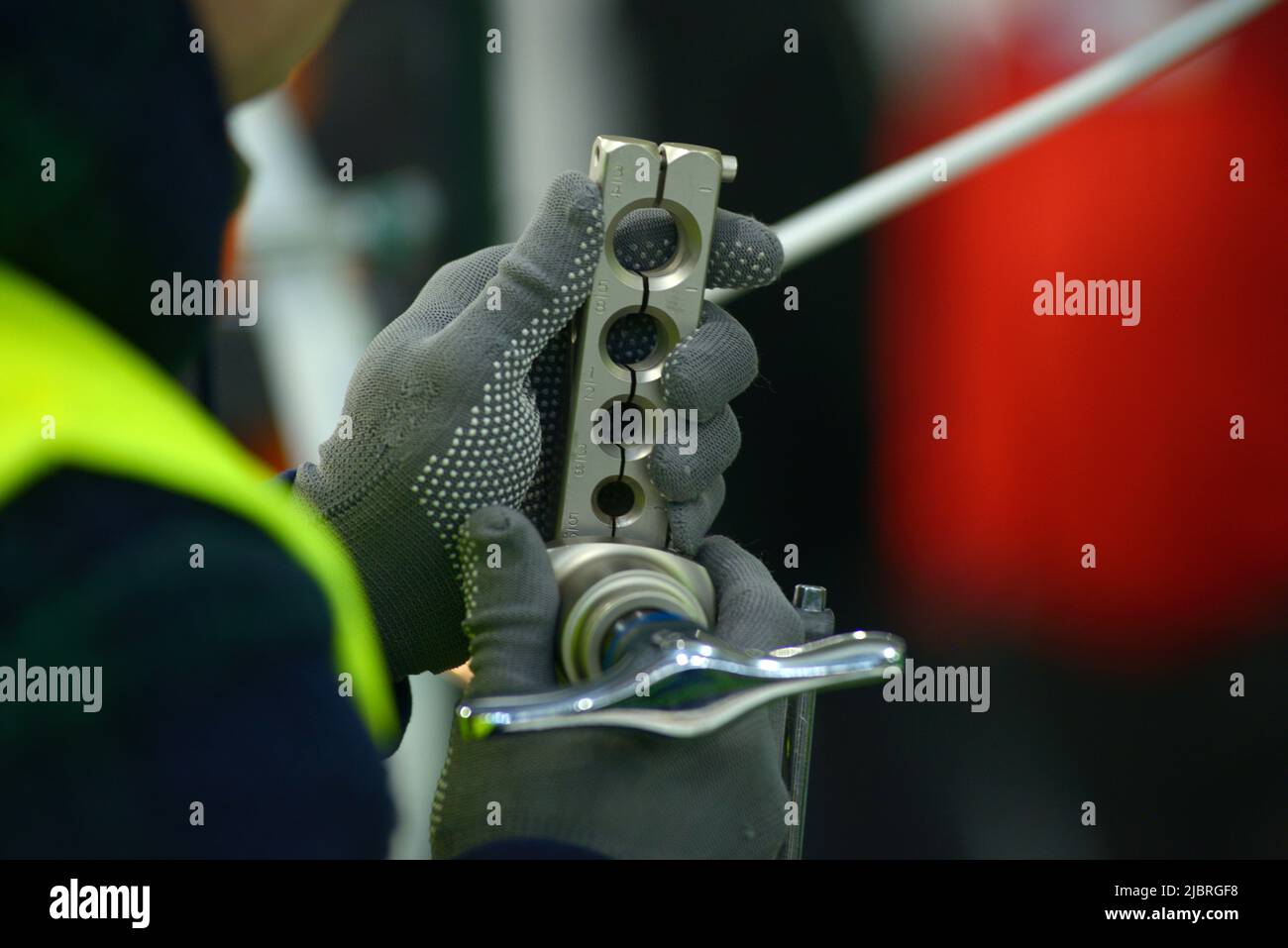 Worker hands fitting clamps for cables of an air conditioner Stock ...