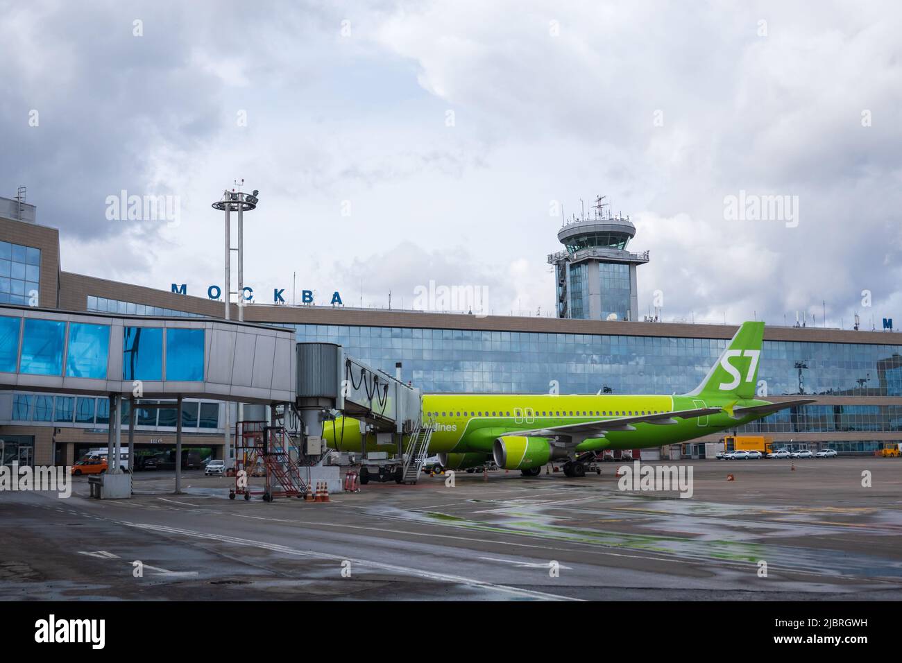 Airplane outside contemporary airport building Stock Photo - Alamy