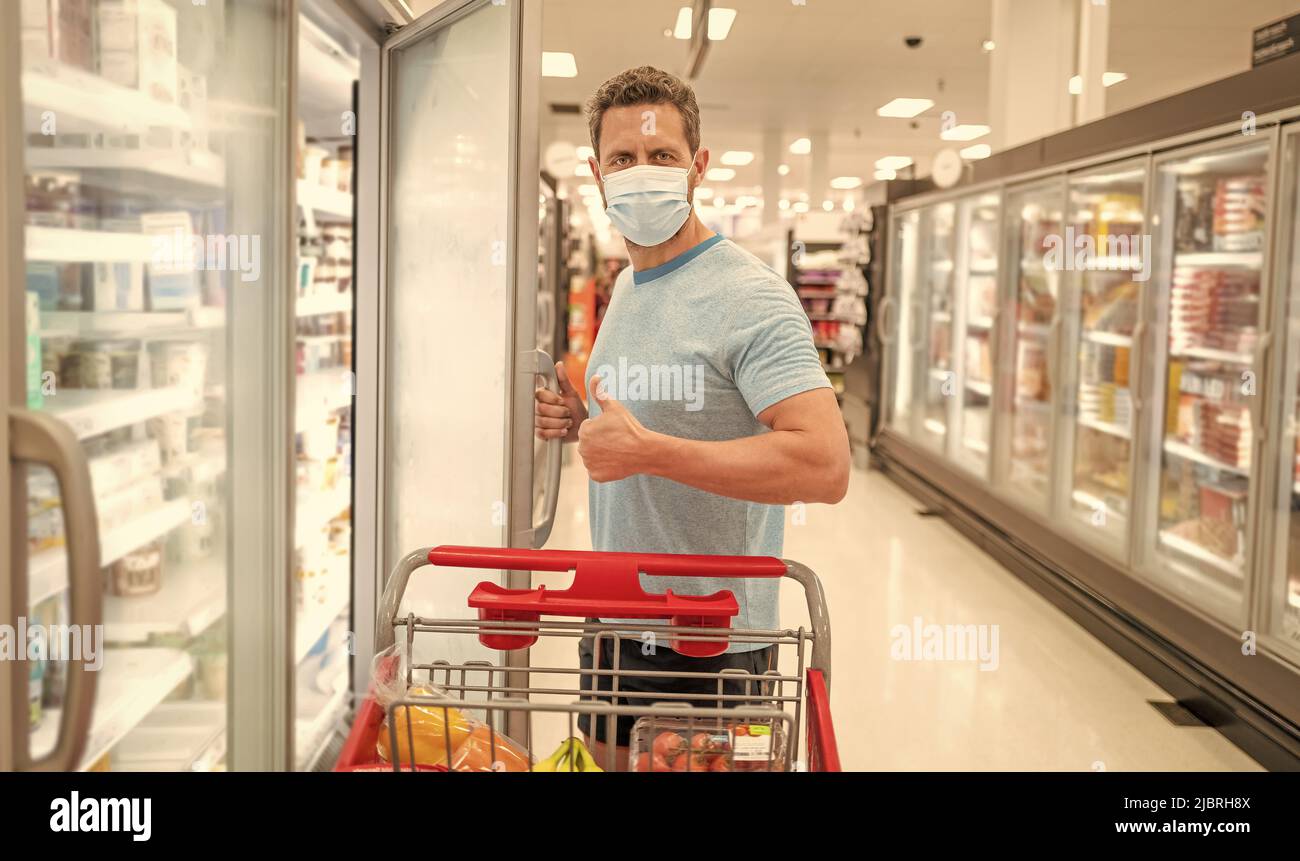 guy at grocery store. shopper at groceries. buying food at supermarket ...