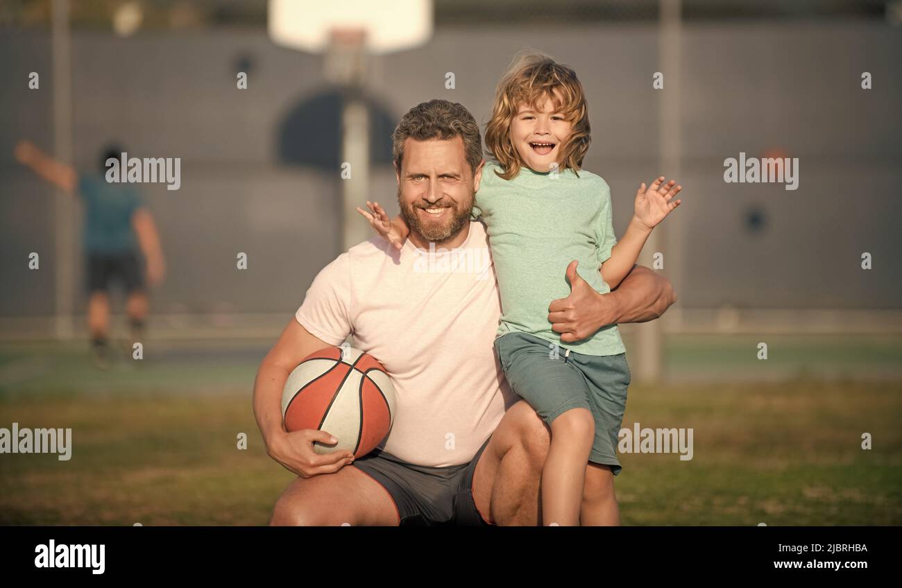 happy fathers day. family portrait. dad and kid boy hold sport ball ...
