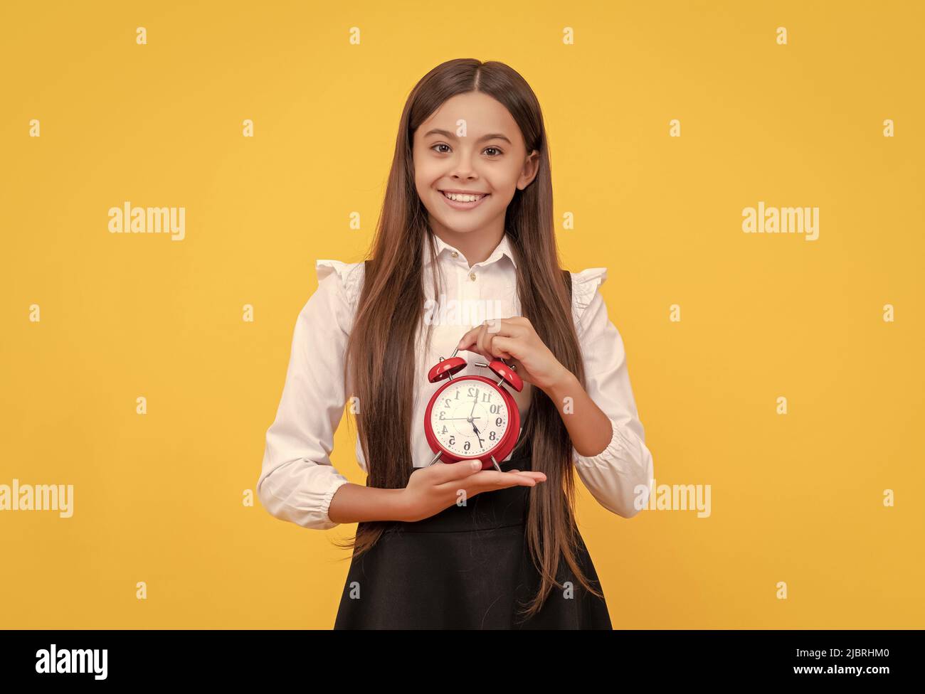 punctual teen girl checking time. happy child with alarm clock. school ...