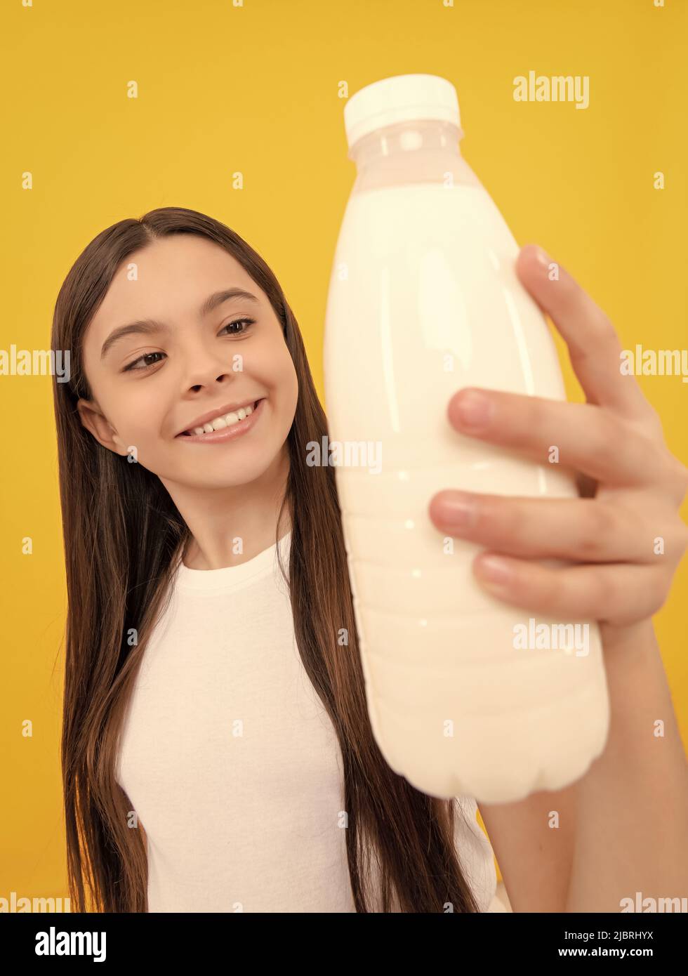 milk bottle in hand of happy child. kid hold dairy beverage product ...