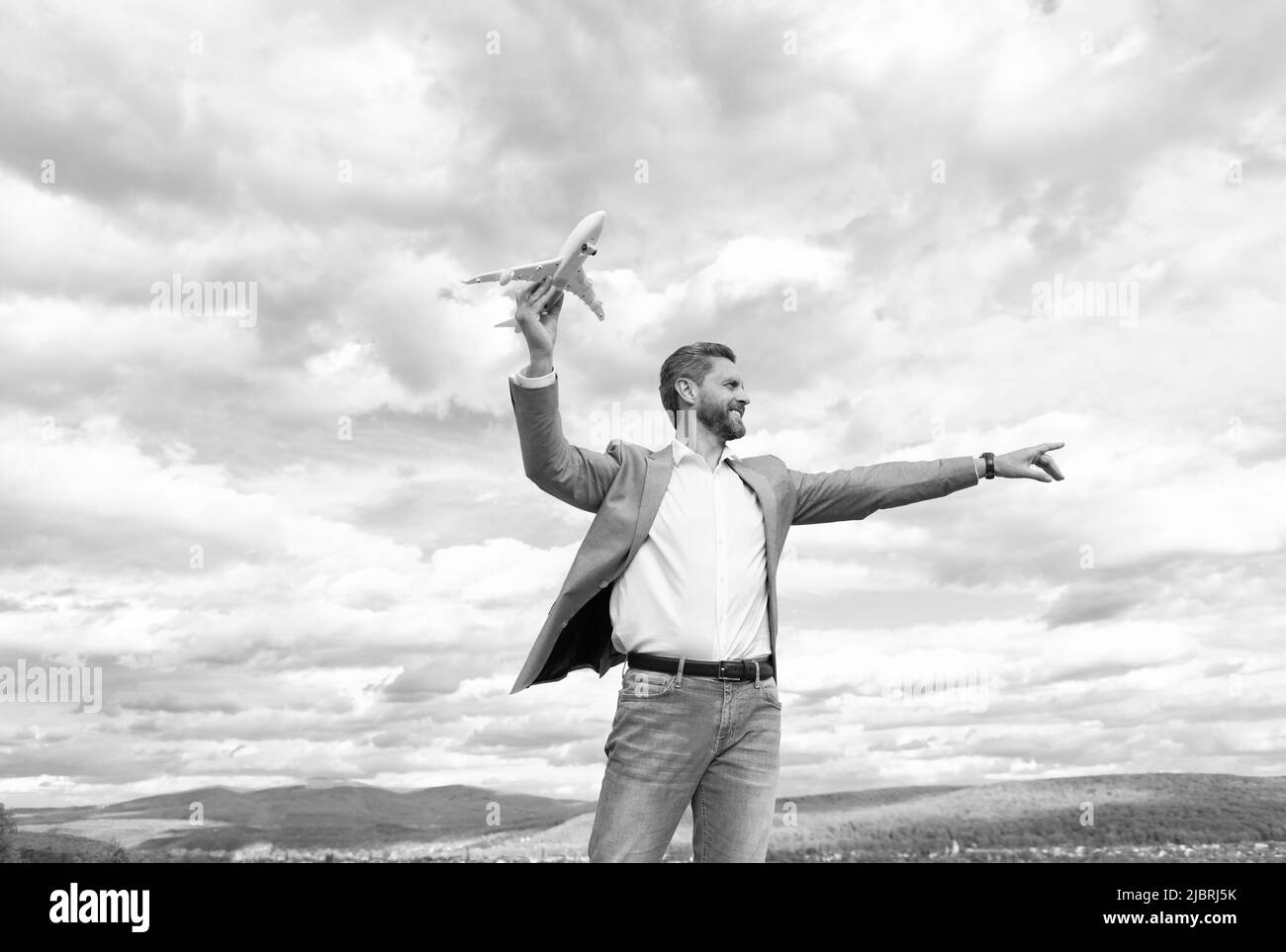 freedom. mature ceo with plane on sky background. confident businessman ...