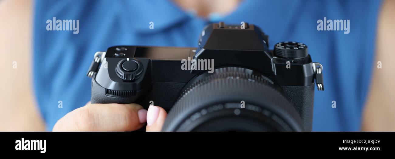 Woman photographer in blue outfit with camera in her hands in photo ...